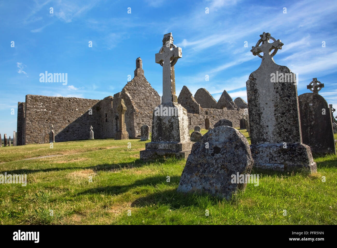 Clonmacnoise Cathedral with the typical crosses and graves. The ...