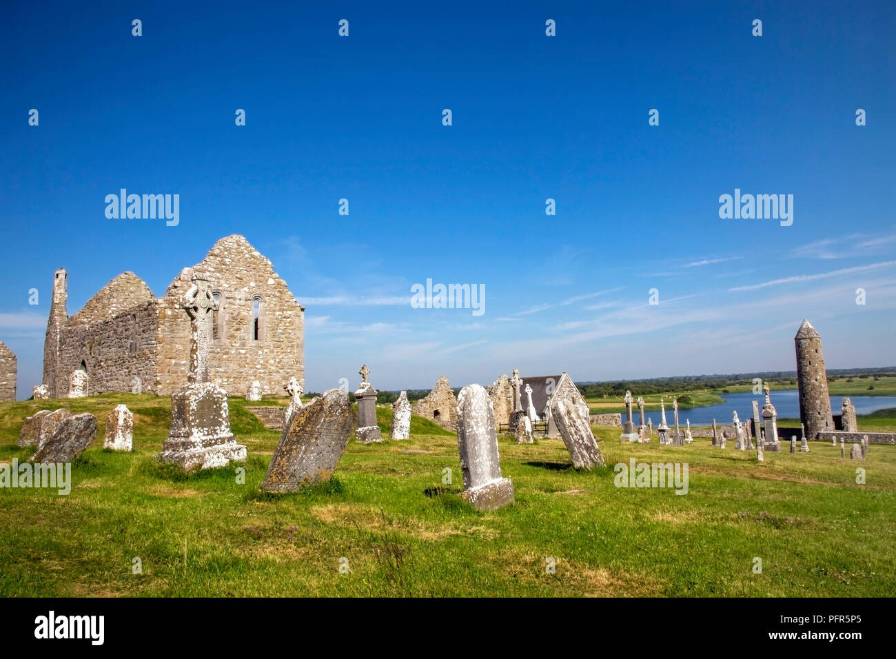 Clonmacnoise Cathedral with the typical crosses and graves. The ...