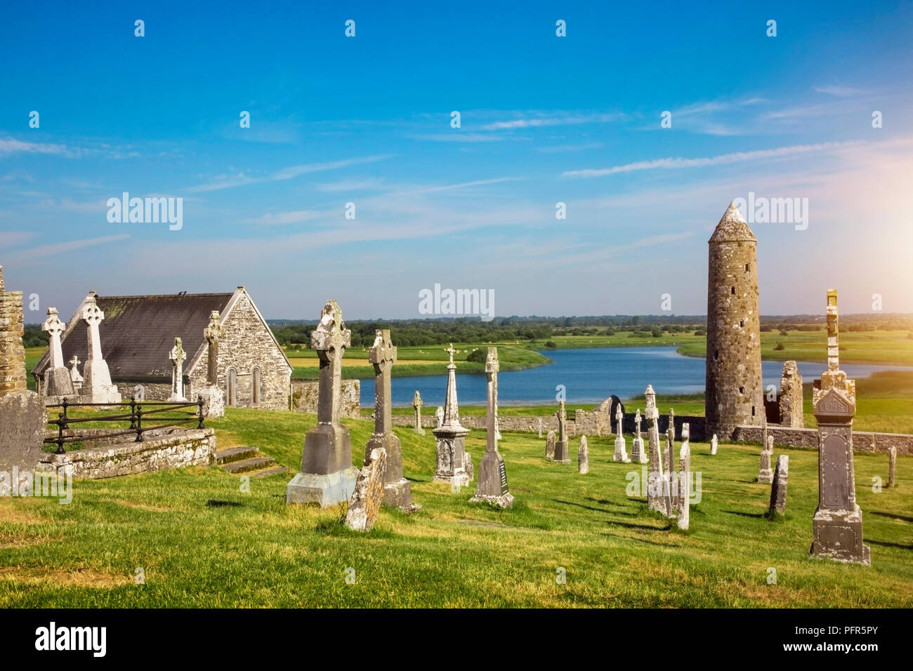 Clonmacnoise Cathedral with the typical crosses and graves. The ...