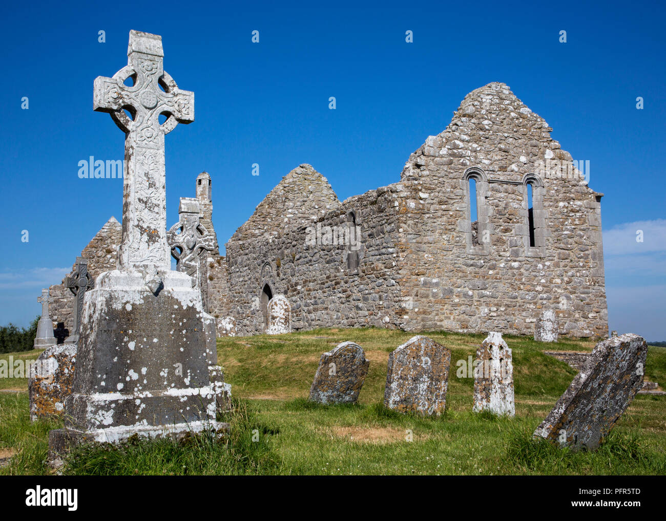 Clonmacnoise Cathedral with the typical crosses and graves. The ...