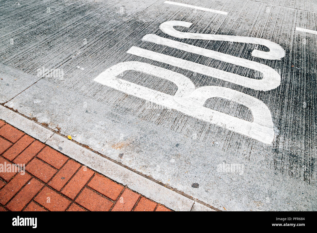 Bus lane sign on asphalt road Stock Photo - Alamy