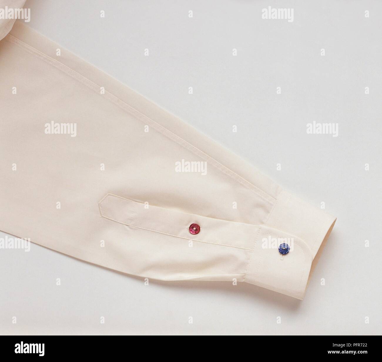 Coloured buttons on cuff of a white shirt, close-up Stock Photo - Alamy