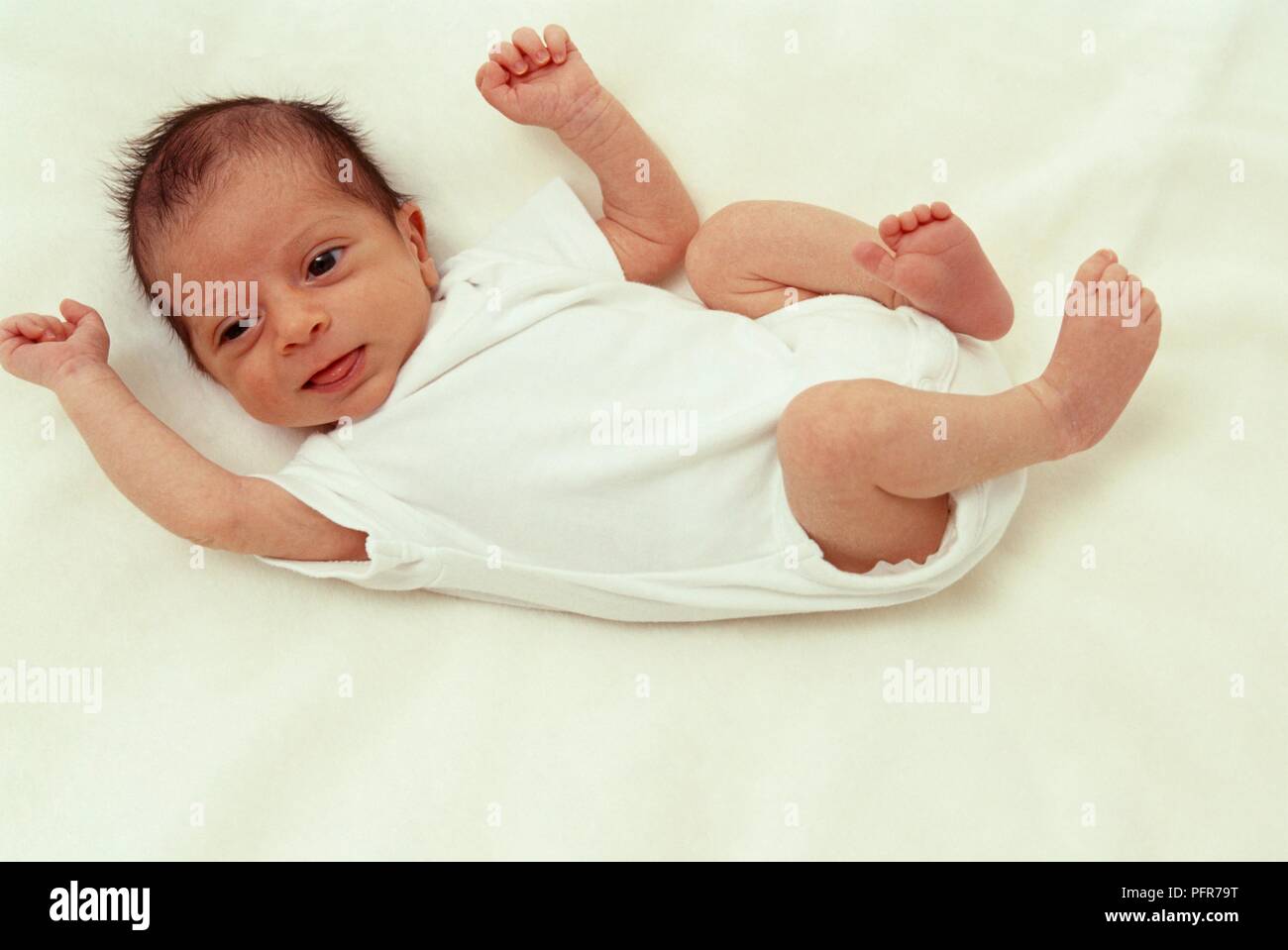 Baby boy lying on his back Stock Photo - Alamy