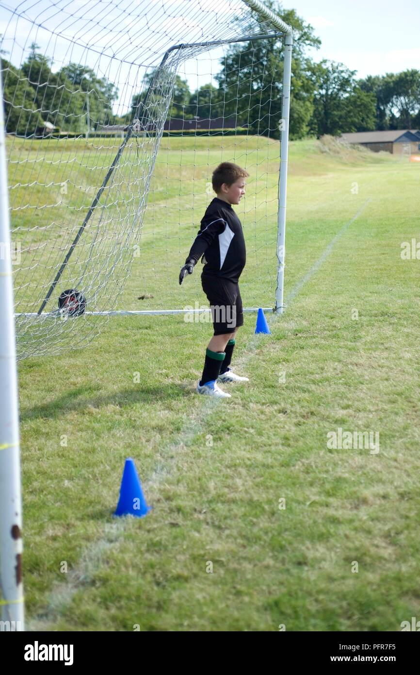 Goalkeeper standing ready in goal, arms out to sides Stock Photo - Alamy