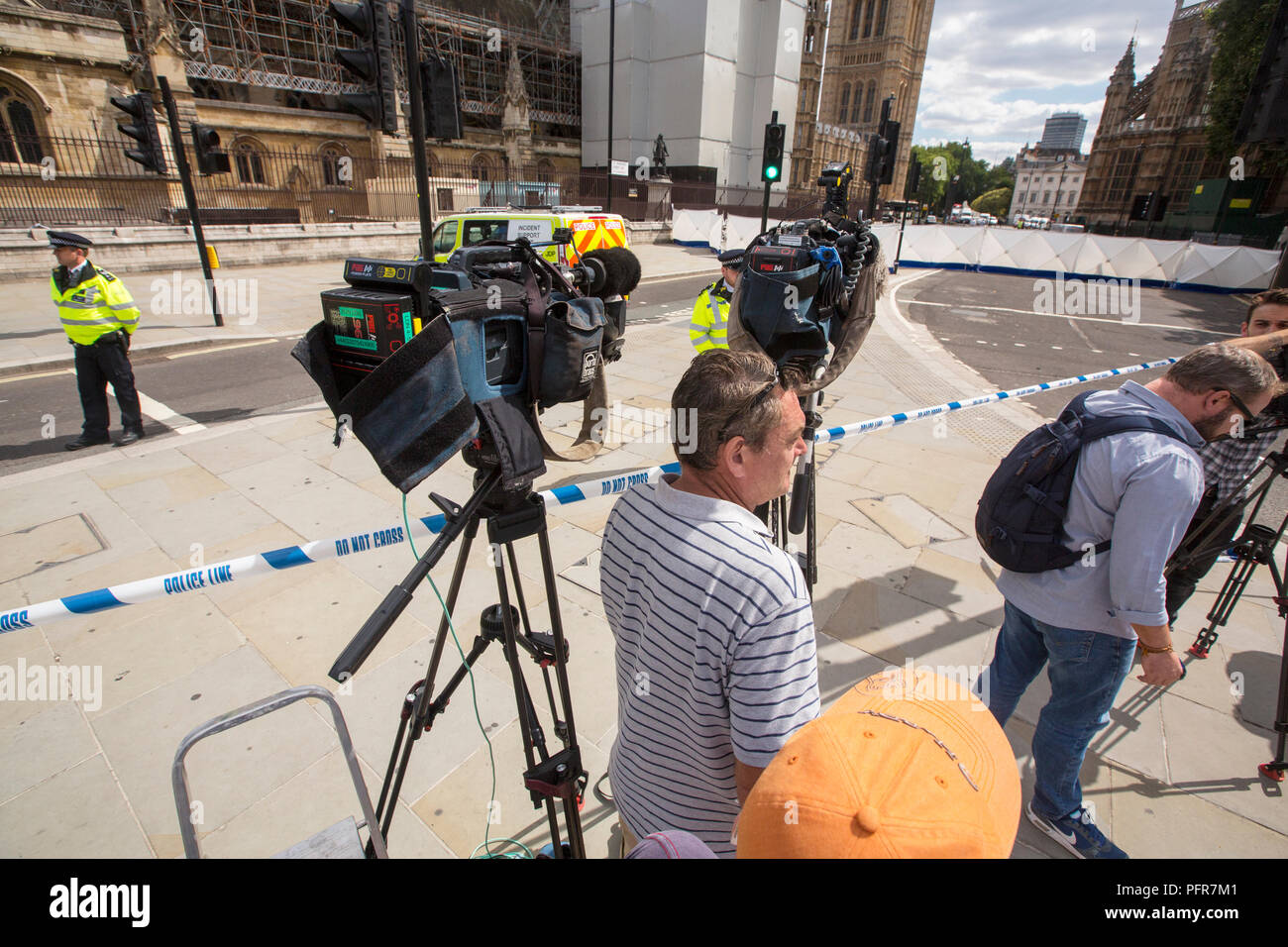 Camera crews filming the aftermath of the latest incident where a man ...