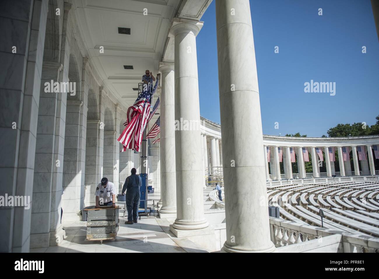 Arlington National Cemetery employees hang American flags in the ...