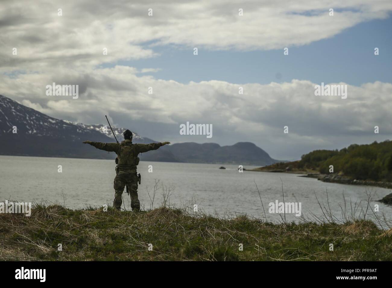 A Norwegian Coastal Ranger Commandos (KJK) signals two oncoming CB90 ...