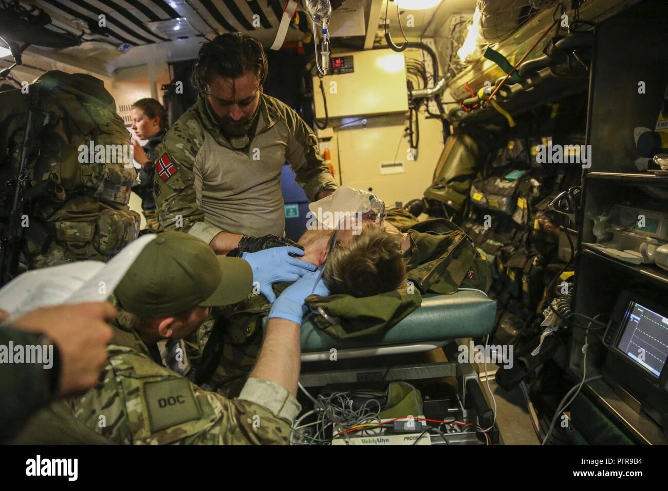 Norwegian Coastal Ranger Commandos (KJK) treat the wounds of a ...