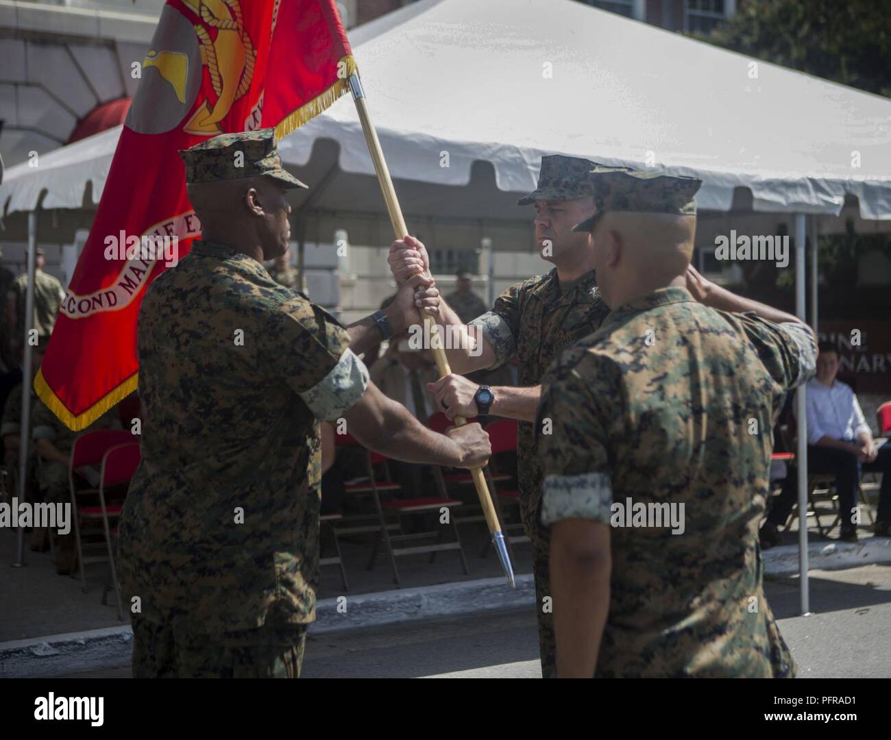 U.S. Marine Corps Brig. Gen. Michael E. Langley, passes the colors to ...