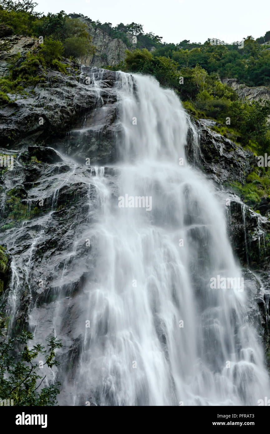 Beautiful high waterfall in swiss Alps, water splash Stock Photo - Alamy