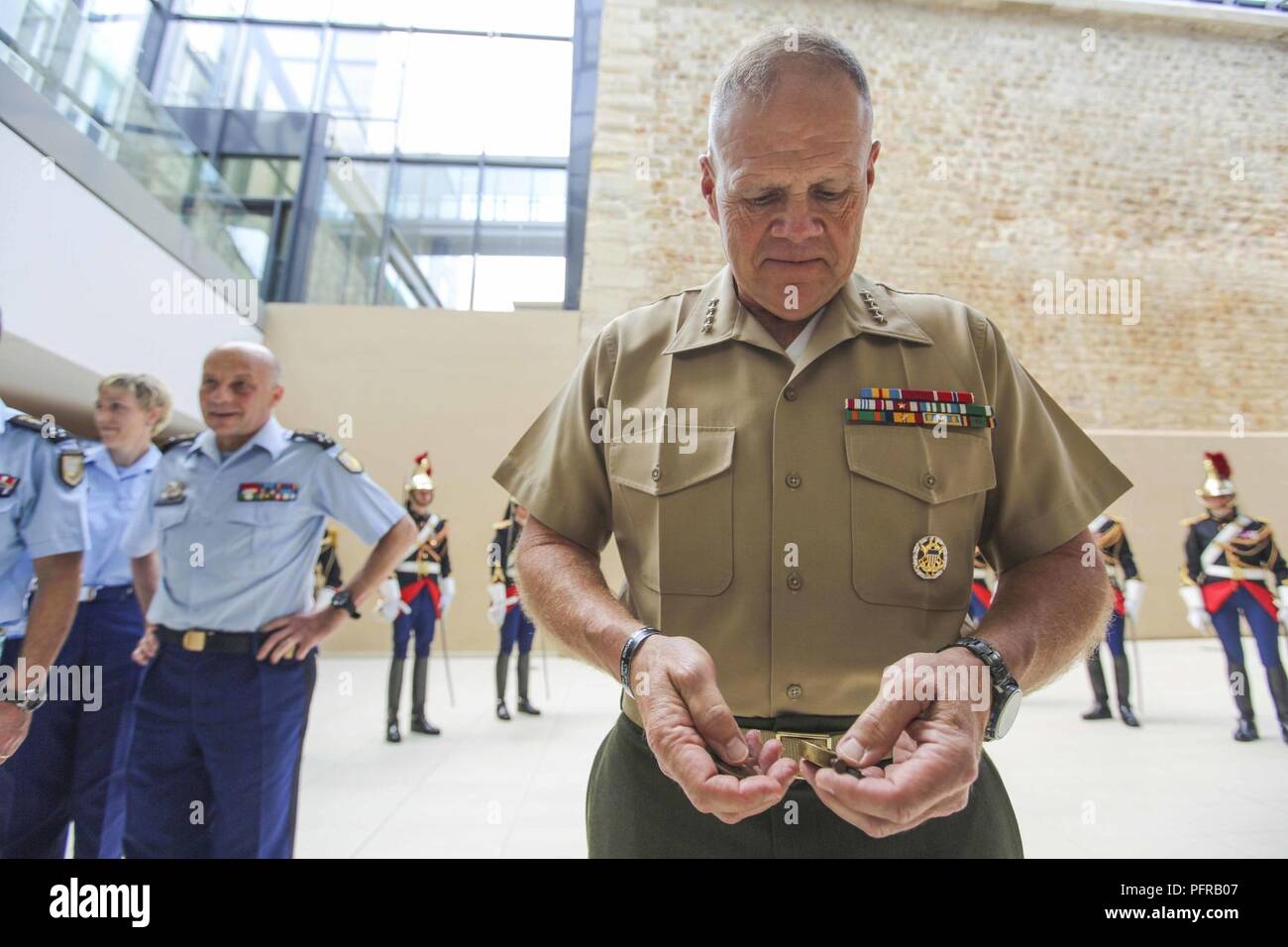 Commandant of the Marine Corps Gen. Robert B. Neller receives a gift ...