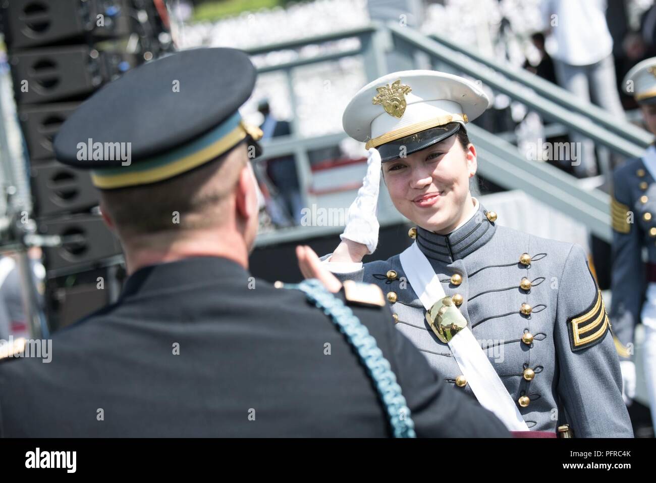 A U.S. Military Academy cadet salutes after recieving their diplomas ...