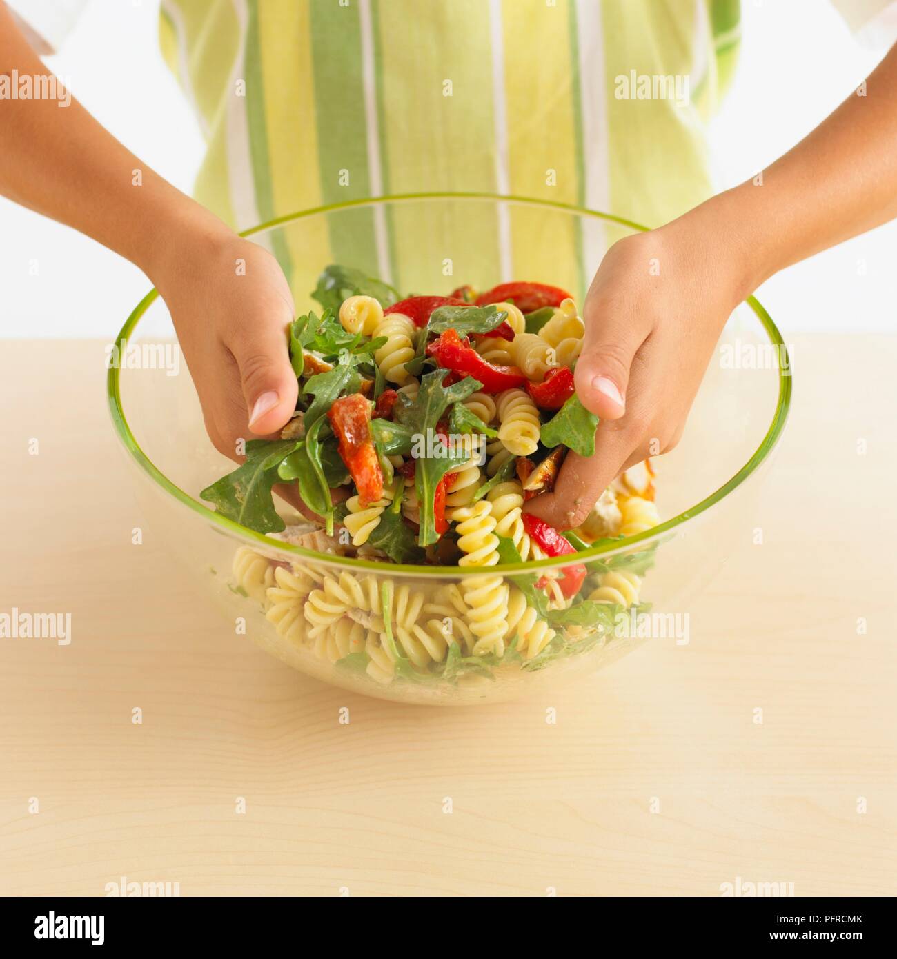 Girl mixing pasta salad with her hands, close-up Stock Photo - Alamy