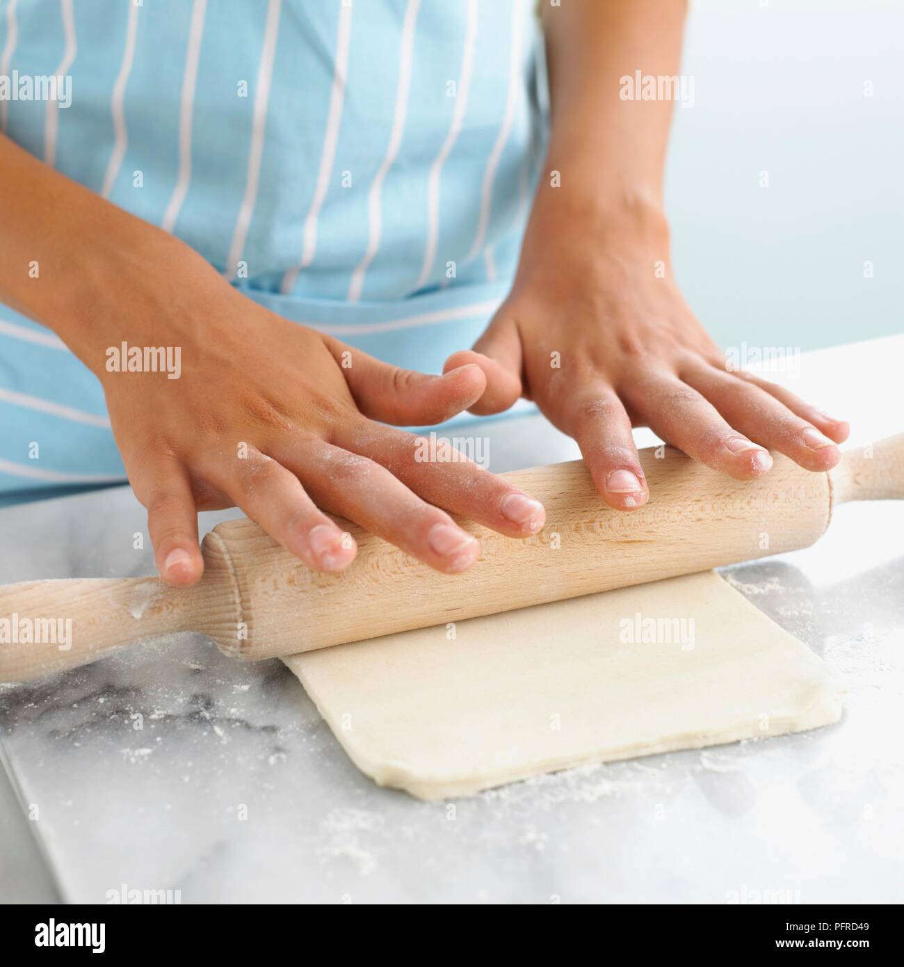Girl rolling puff pastry with rolling pin, close-up Stock Photo - Alamy