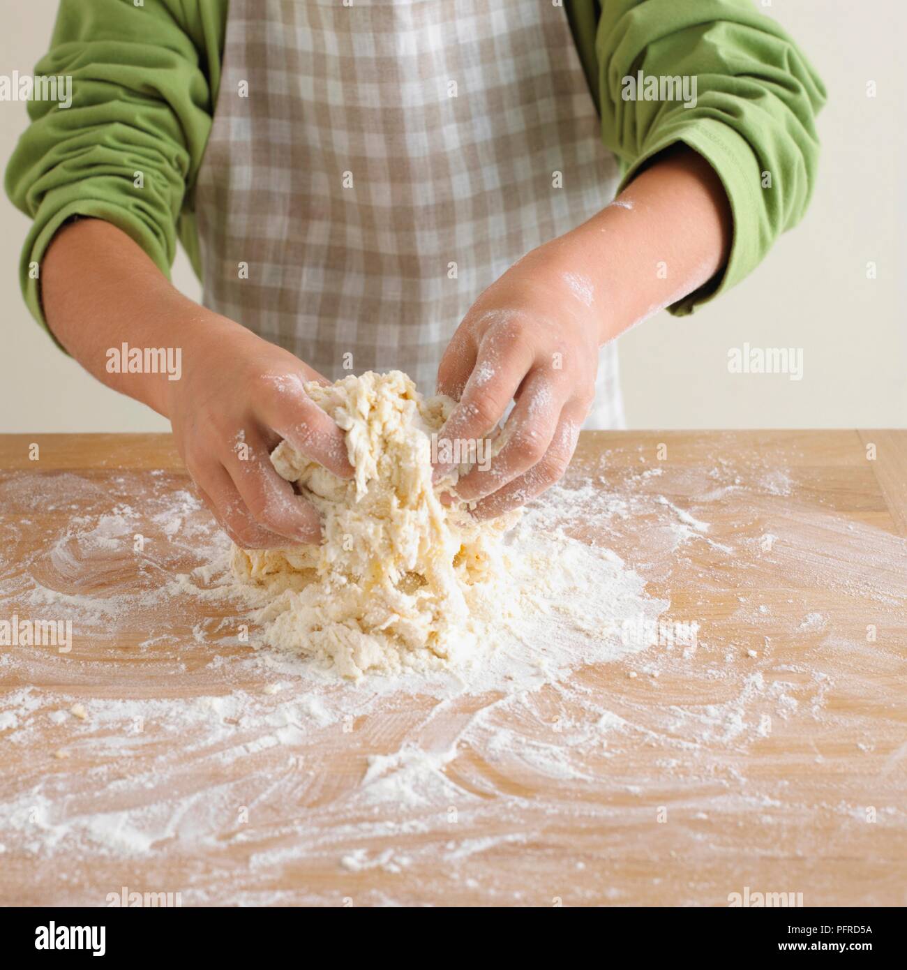 Boy kneading pasta dough on floured surface, close-up Stock Photo - Alamy