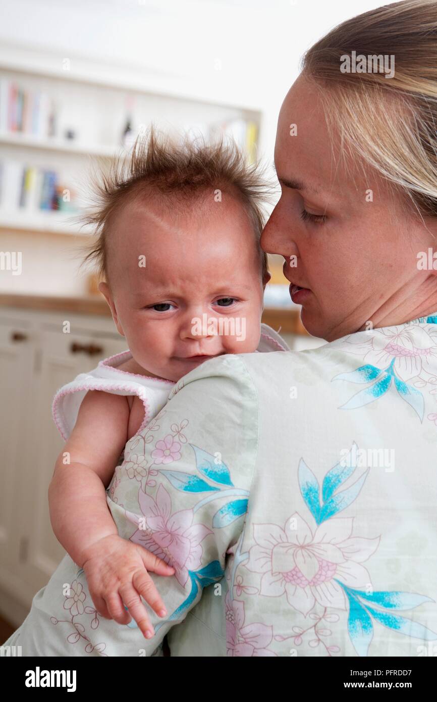 Mother carrying child over shoulder hi-res stock photography and images ...