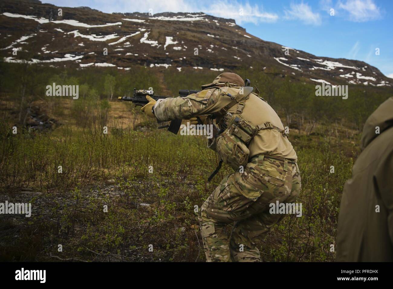 A Norwegian Coastal Ranger Commando (KJK) returns fire on opposing ...