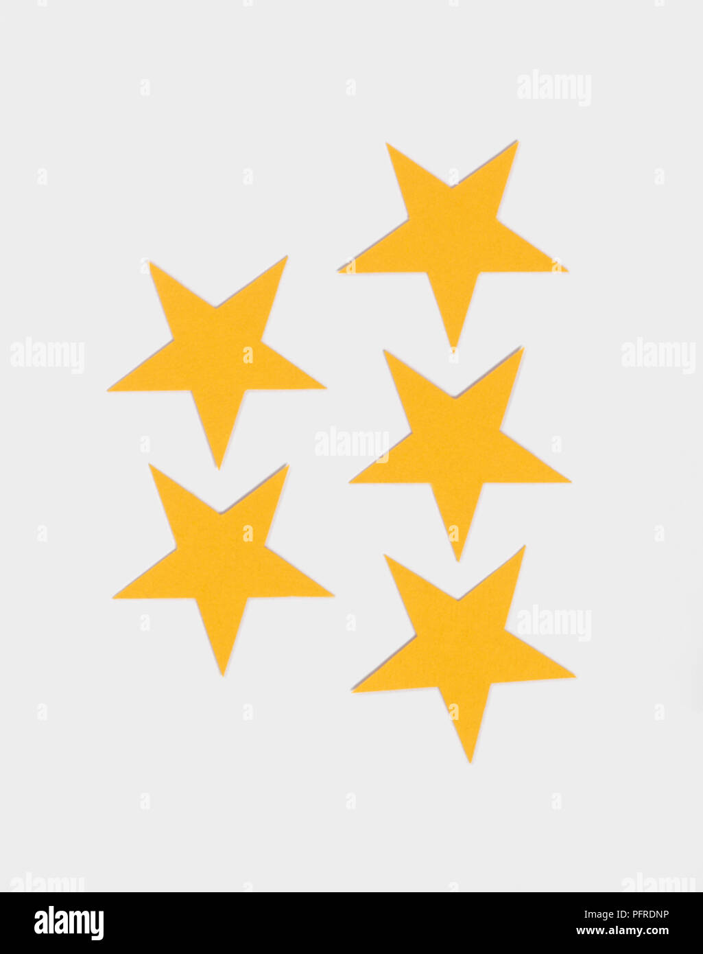 Five yellow paper stars on white background Stock Photo - Alamy