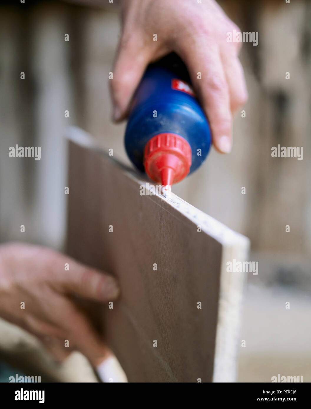 Using strong wood adhesive on edge of plywood, part of bird tableclose ...
