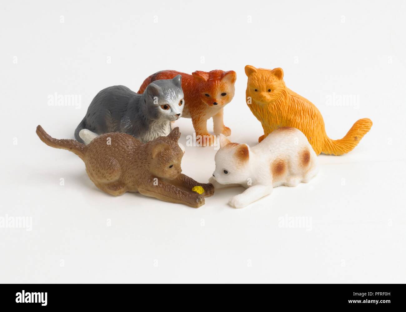 Five small plastic toy kittens playing Stock Photo - Alamy