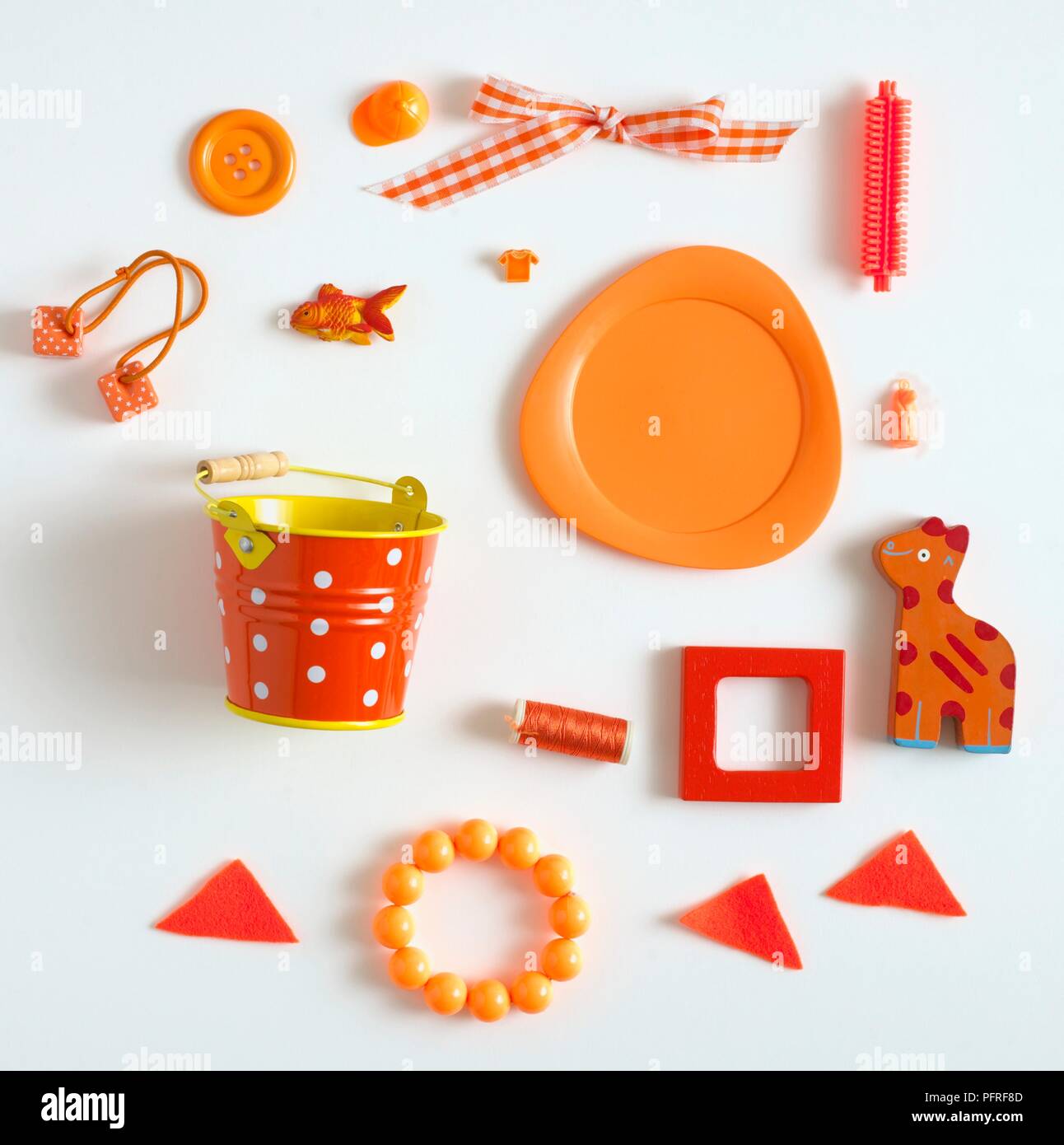 Orange toys and objects arranged on white background Stock Photo - Alamy
