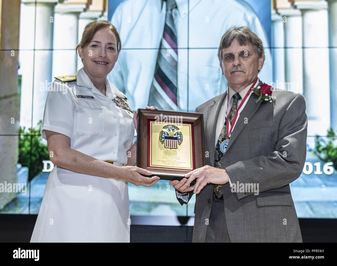 Harvey P. Hodak receives a plaque and medal from Defense Logistics ...