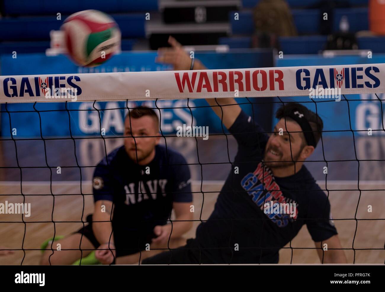 U.S. Coast Guard Seaman Chris North, of Team Navy, spikes a volleyball ...