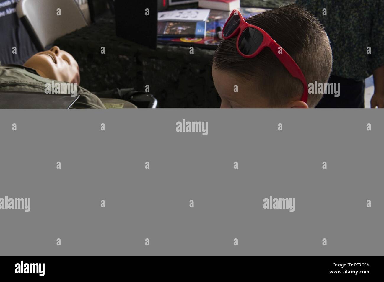 A boy plays with a static medical display during the Cannon Air Force ...