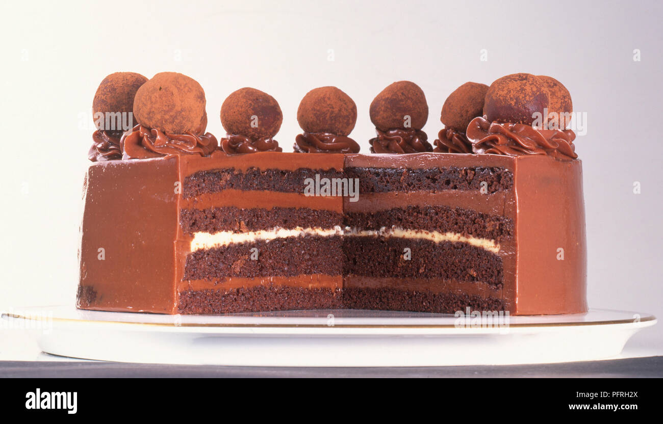 Chocolate truffle torte with slice taken out Stock Photo - Alamy