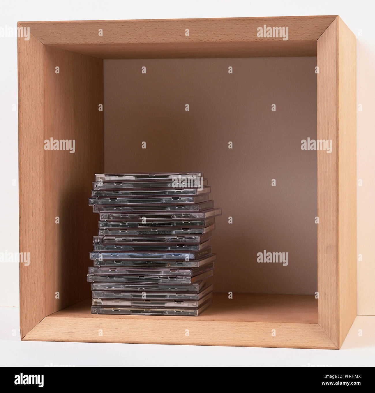 Stack of compact discs in modern wooden storage box on shelf Stock ...