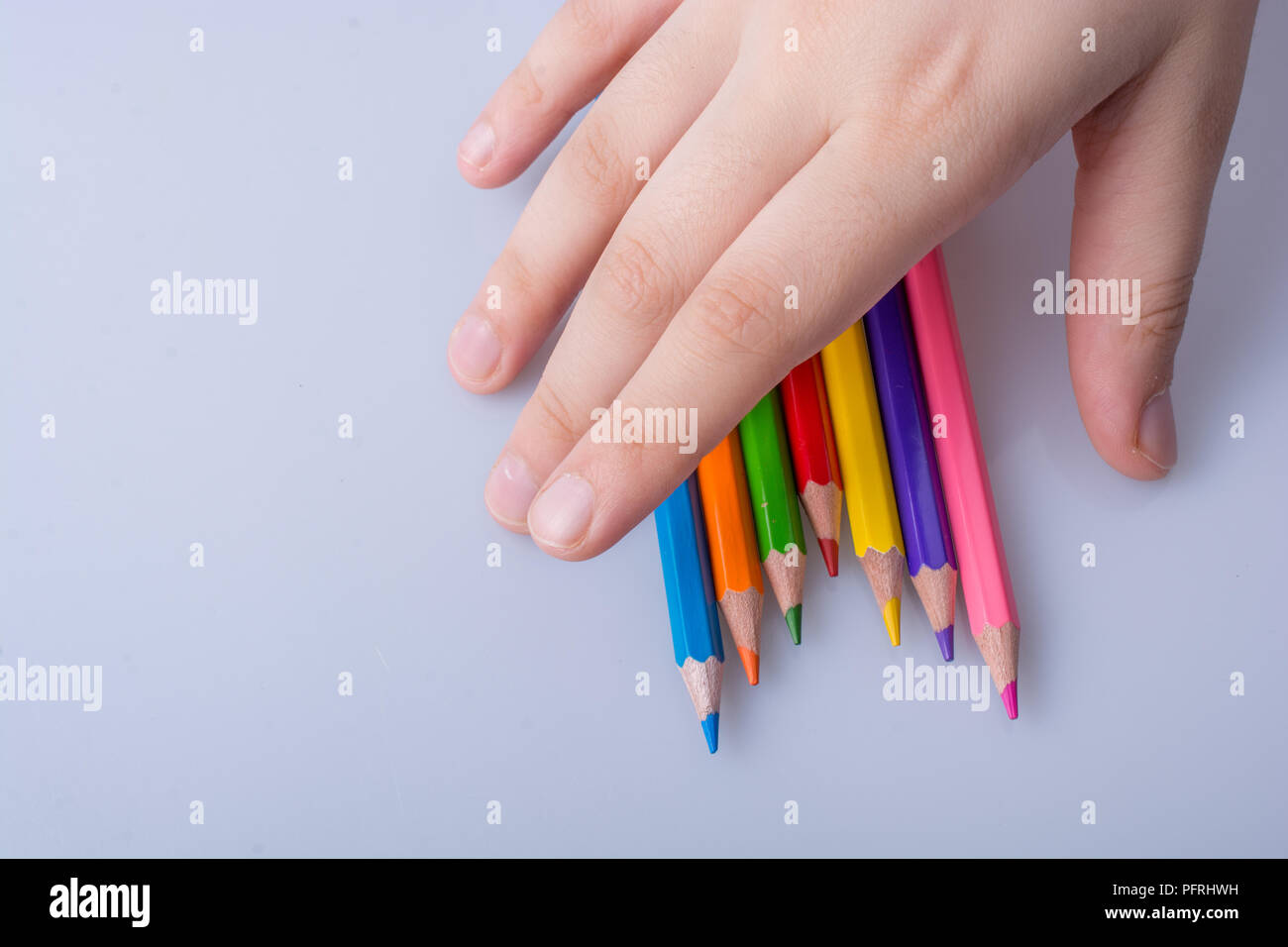 Hand holding color Pencils placed on a white background Stock Photo - Alamy