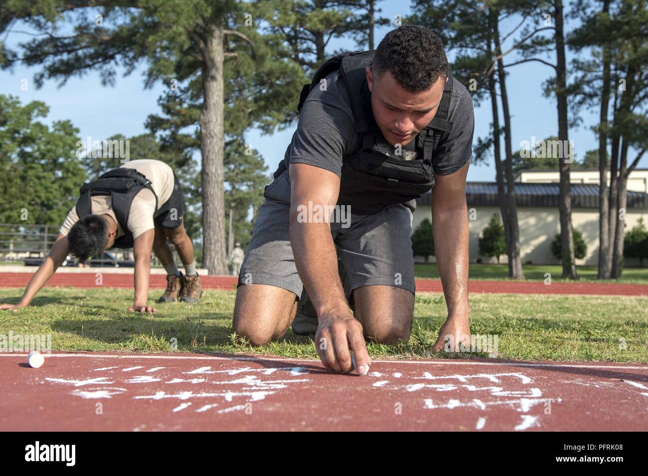 Senior Airman Alex Bertsch, 4th Operations Support Squadron, uses chalk ...