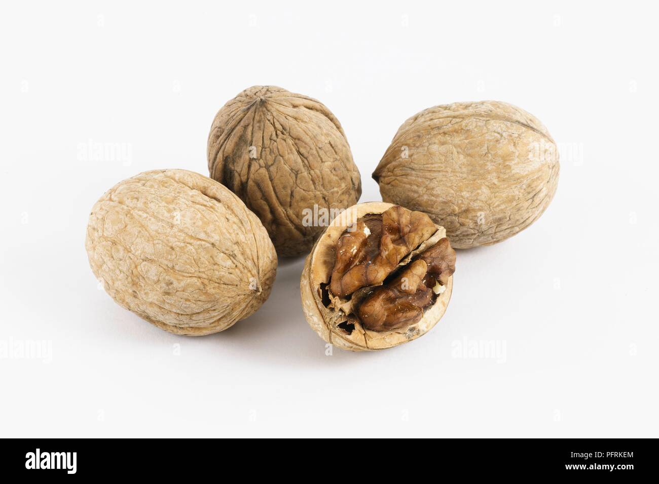 Three whole and one halved sorrento walnuts Stock Photo - Alamy