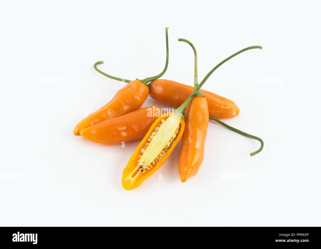 Whole and sliced yellow Aji chili peppers Stock Photo - Alamy