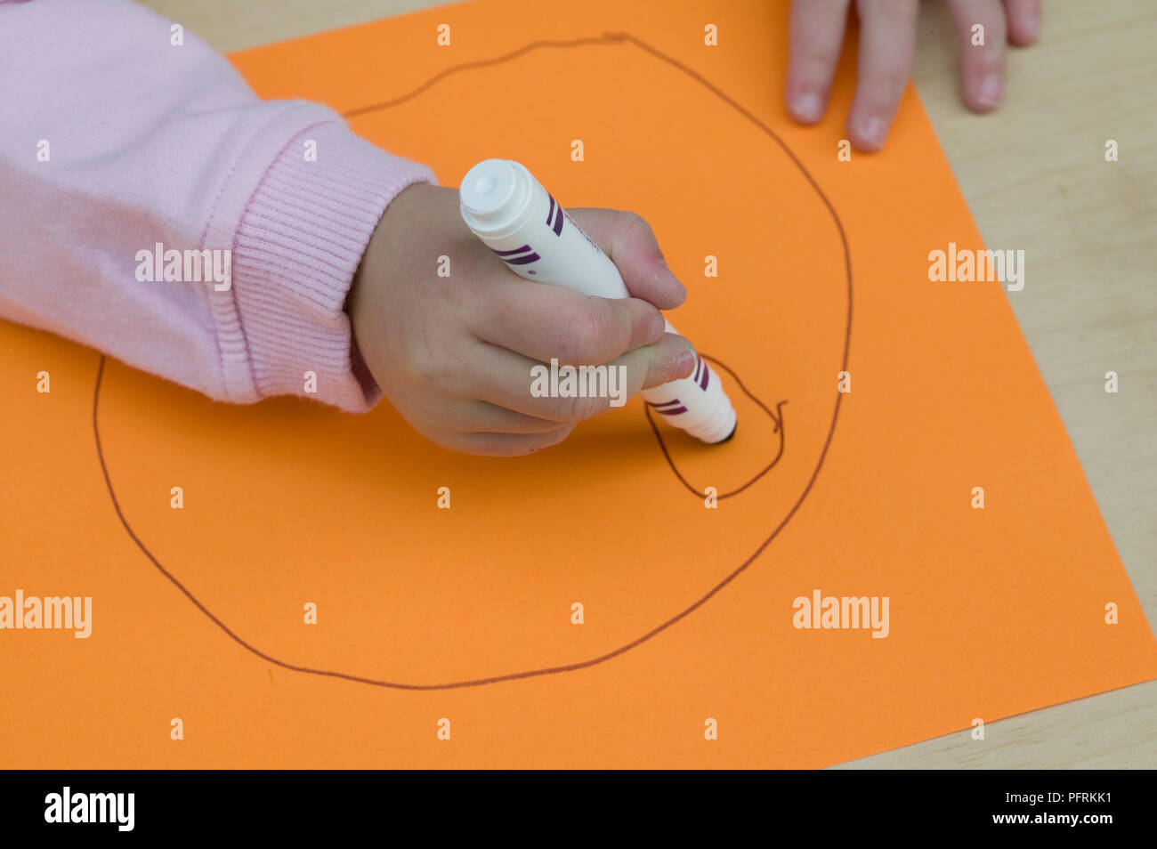 Girl drawing face with marker pen Stock Photo - Alamy