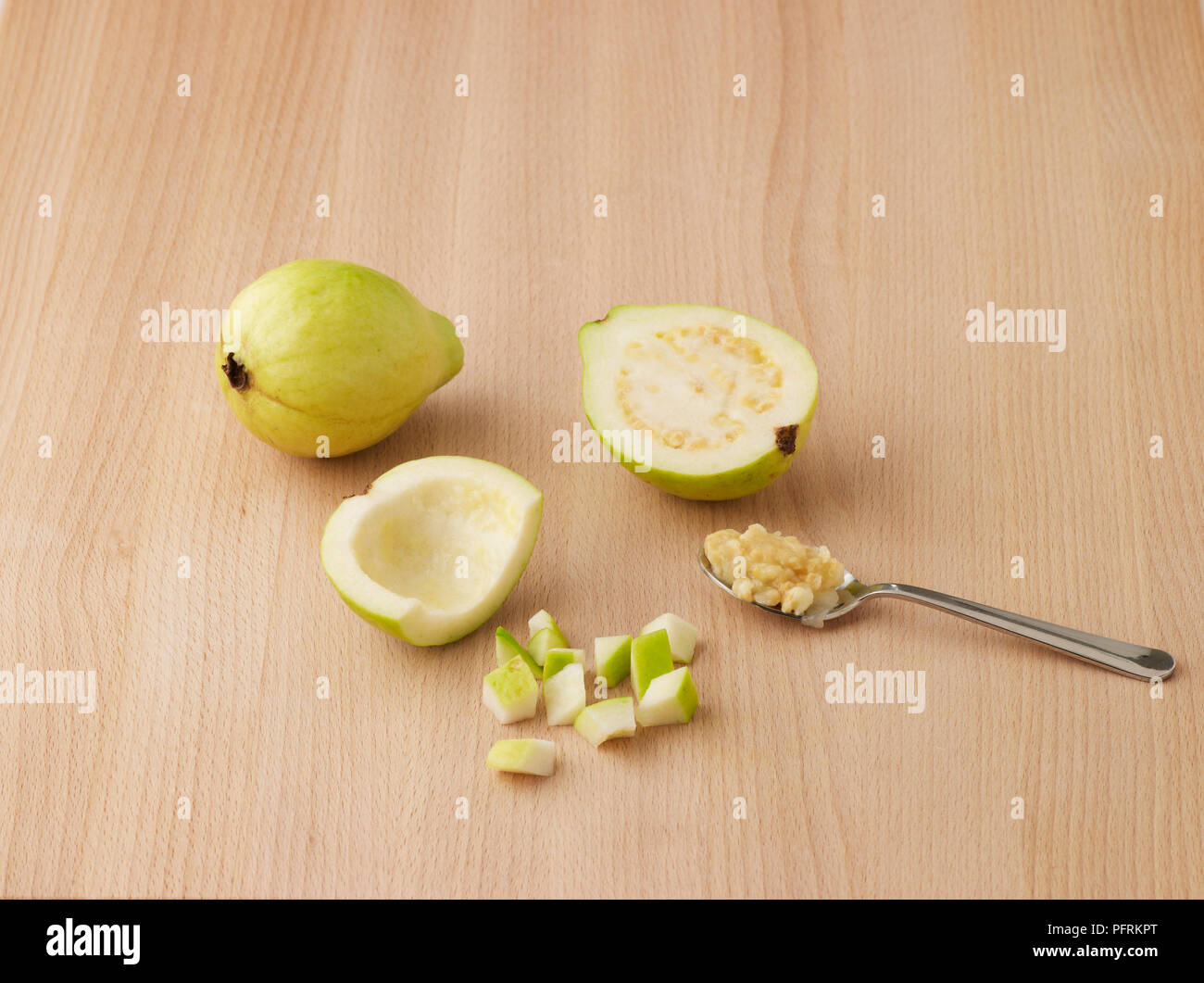 Guavas, whole and sliced with seeds scooped out Stock Photo - Alamy