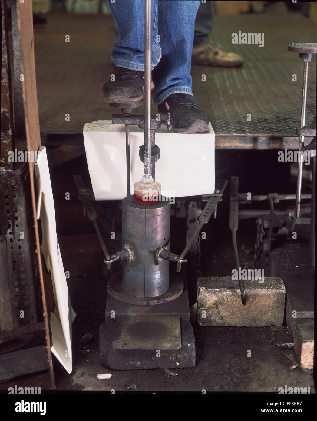 Step in the traditional making of a glass bottle, closing the mould ...