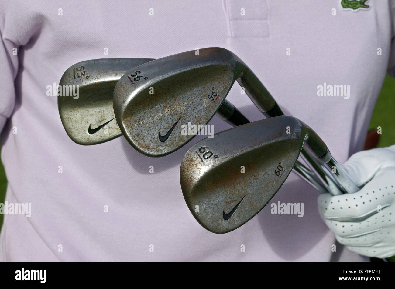 Man holding three irons in gloved hand Stock Photo - Alamy