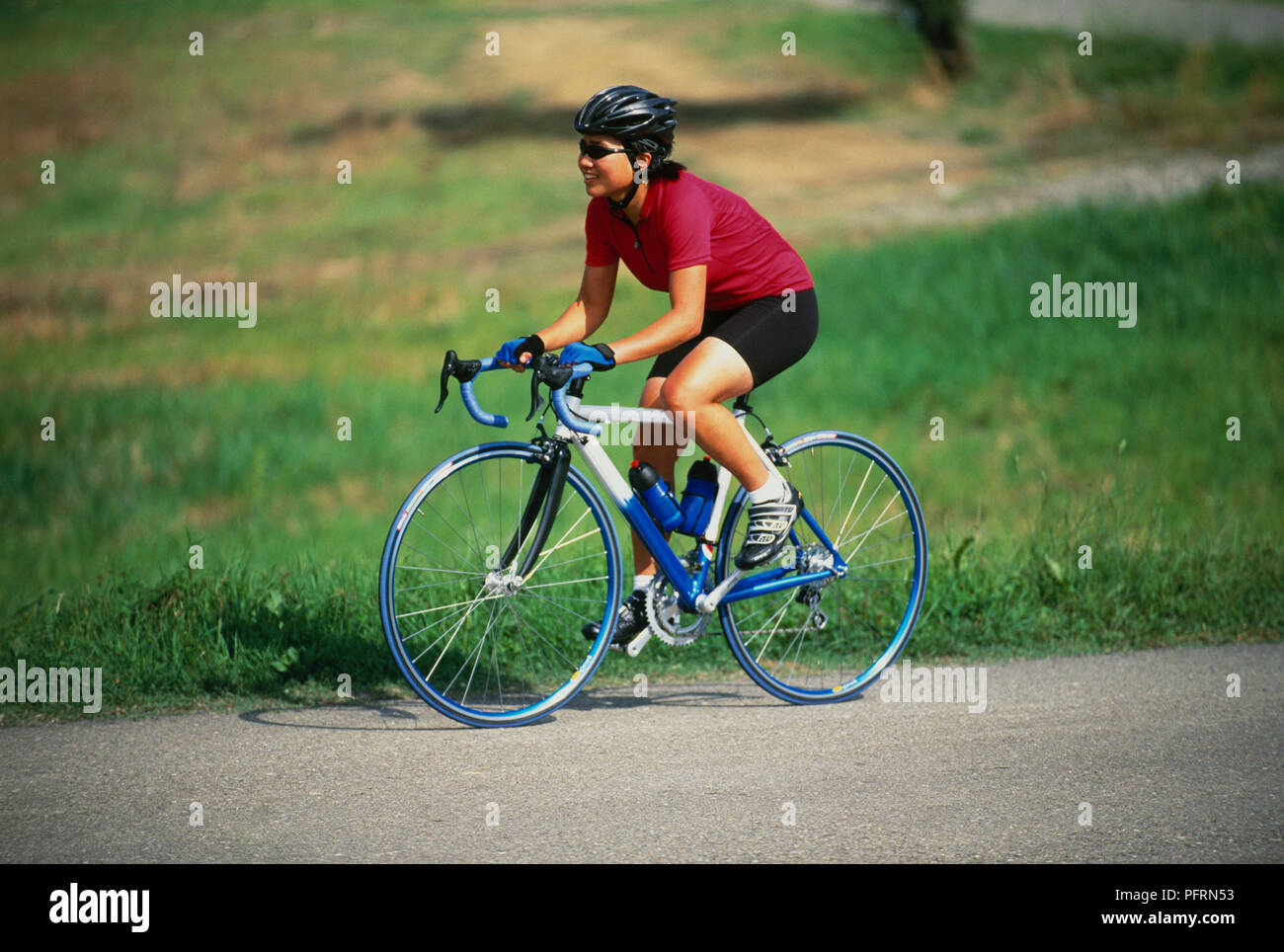 Side view of woman on bike hi-res stock photography and images - Alamy