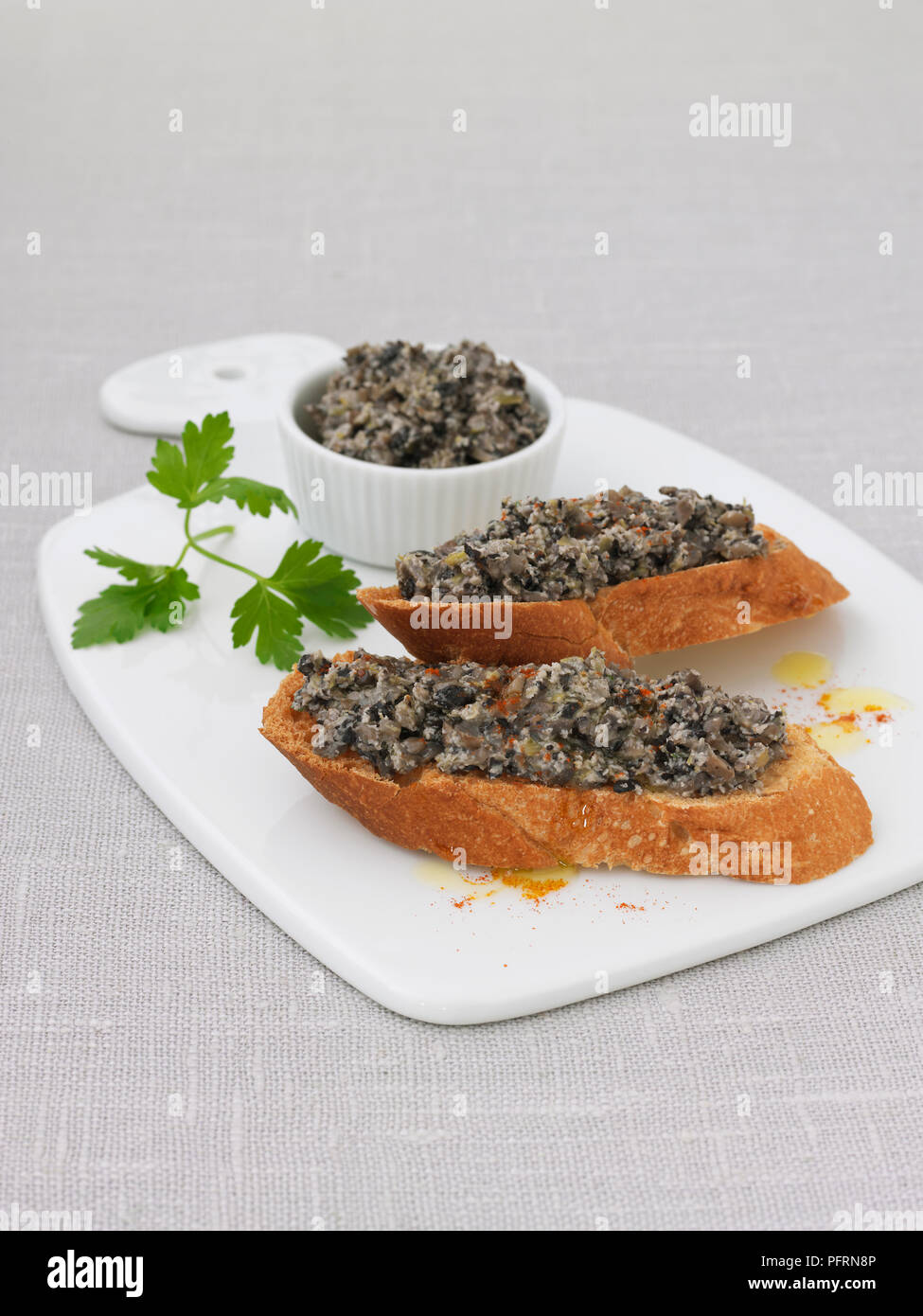 Mushroom and mascarpone dip on toasted ciabatta with pot of dip on ...