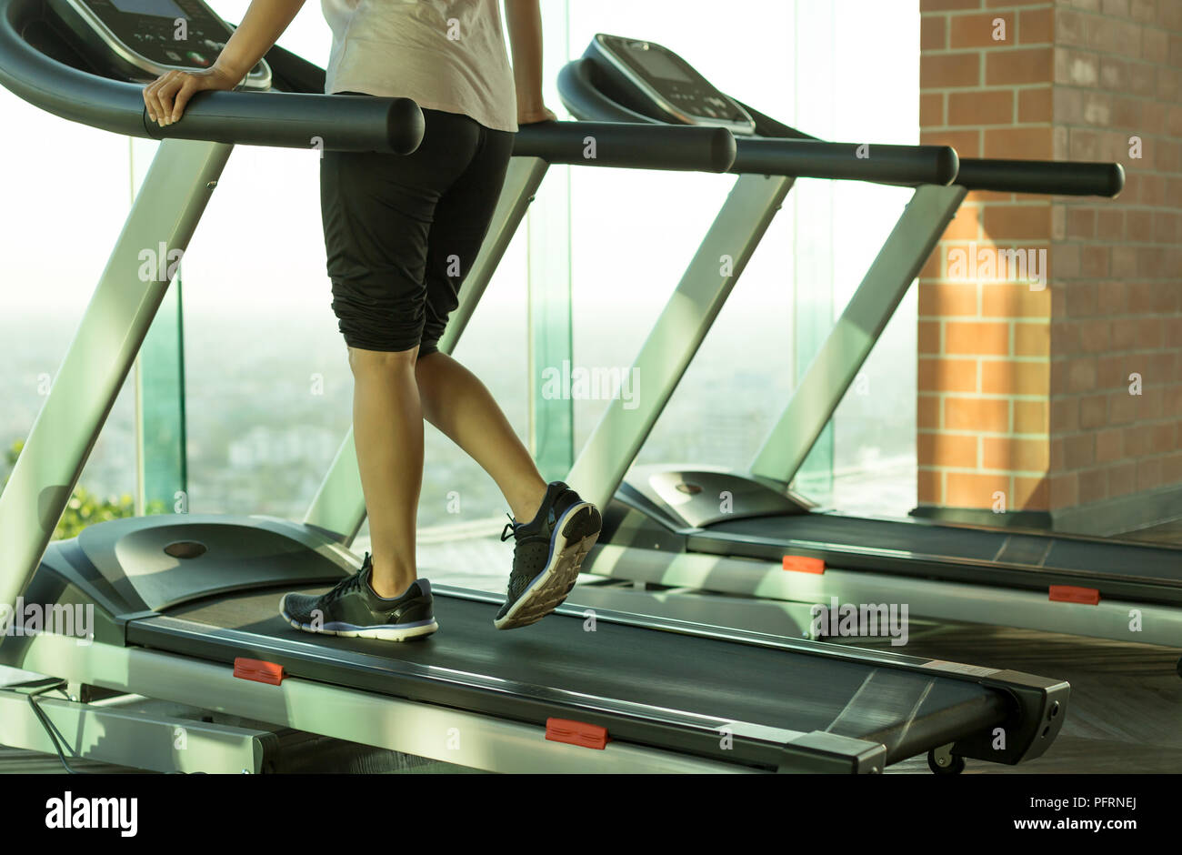 Woman walking on a treadmill exercise in the gym Stock Photo - Alamy