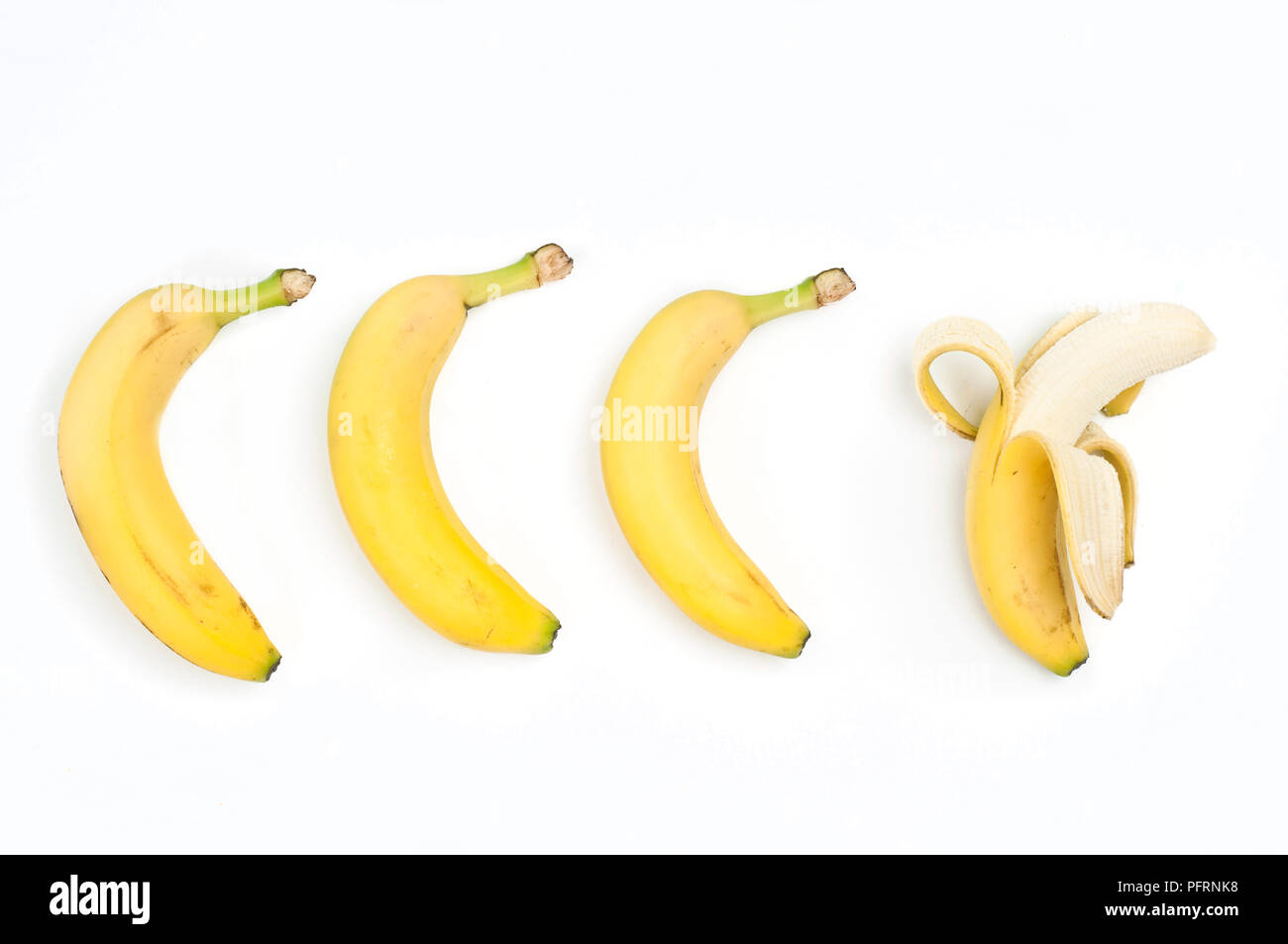 Three bananas with their skin on, and one peeled banana Stock Photo - Alamy