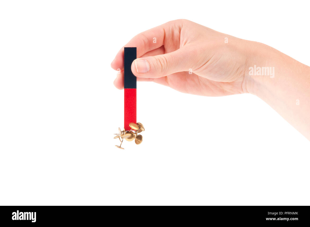 Hand holding magnet with push pins attached at the bottom Stock Photo ...