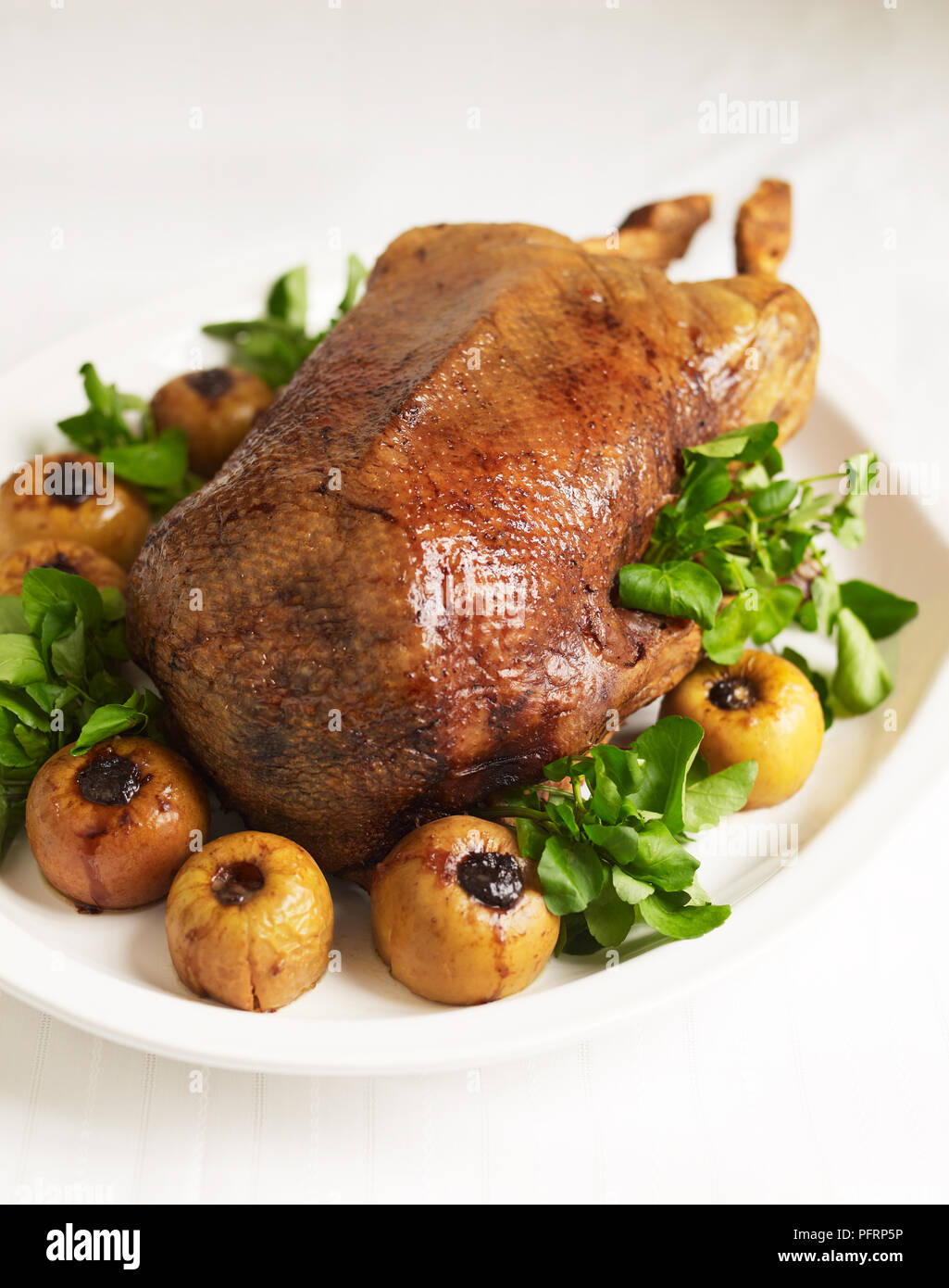 Roast goose with garnish, on a serving plate Stock Photo - Alamy
