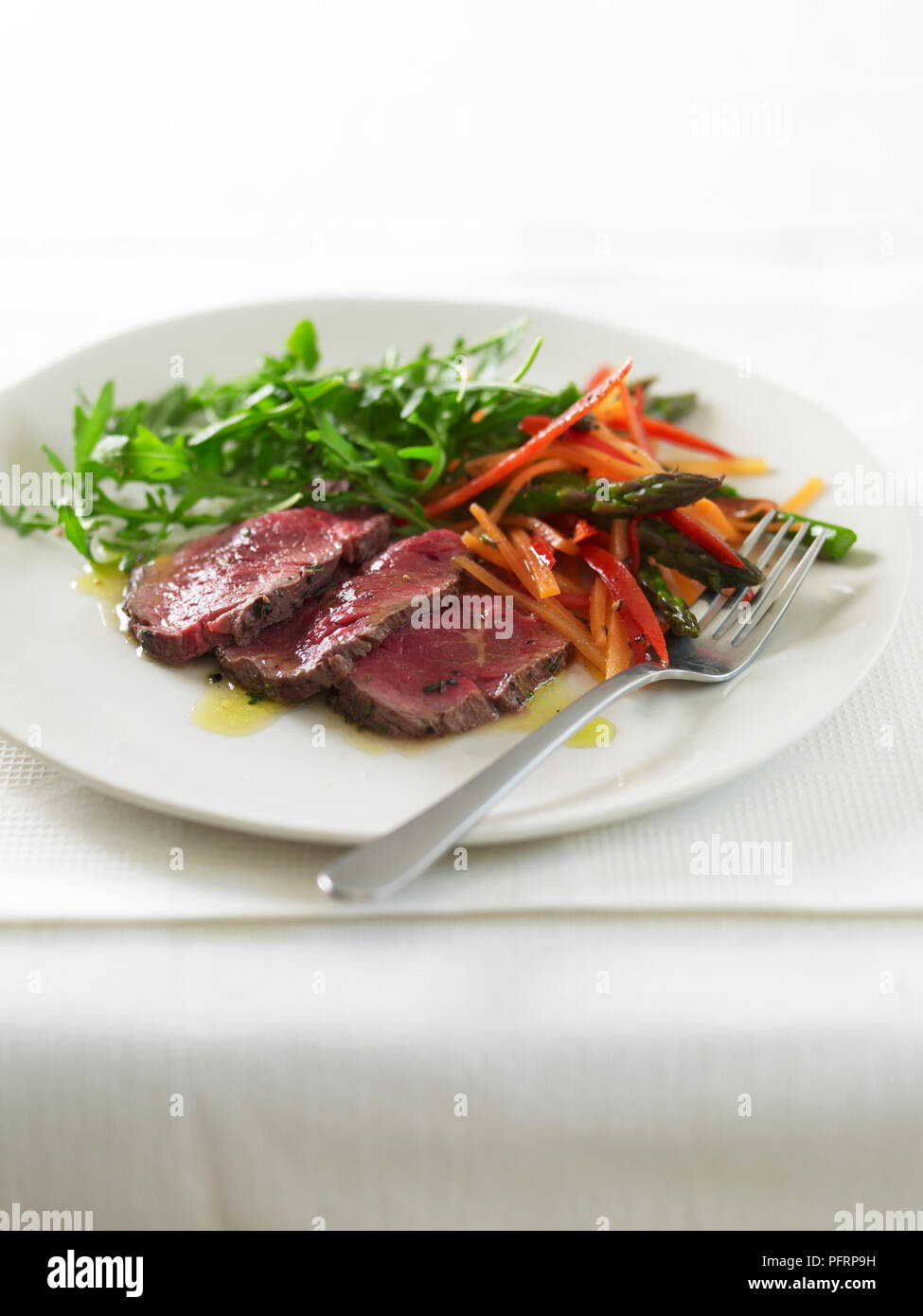 Beef carpaccio with julienne vegetables and rocket leaves Stock Photo ...