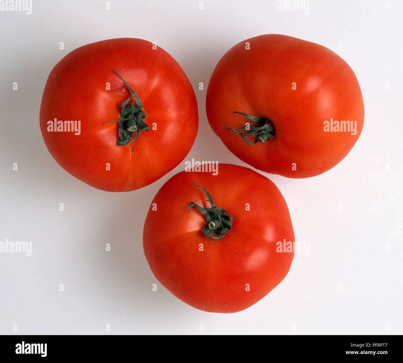 Three red beef tomatoes Stock Photo - Alamy