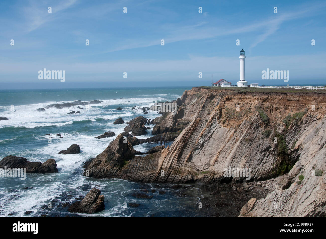 USA, California, Point Arena Lighthouse on cliff with sea crashing over ...
