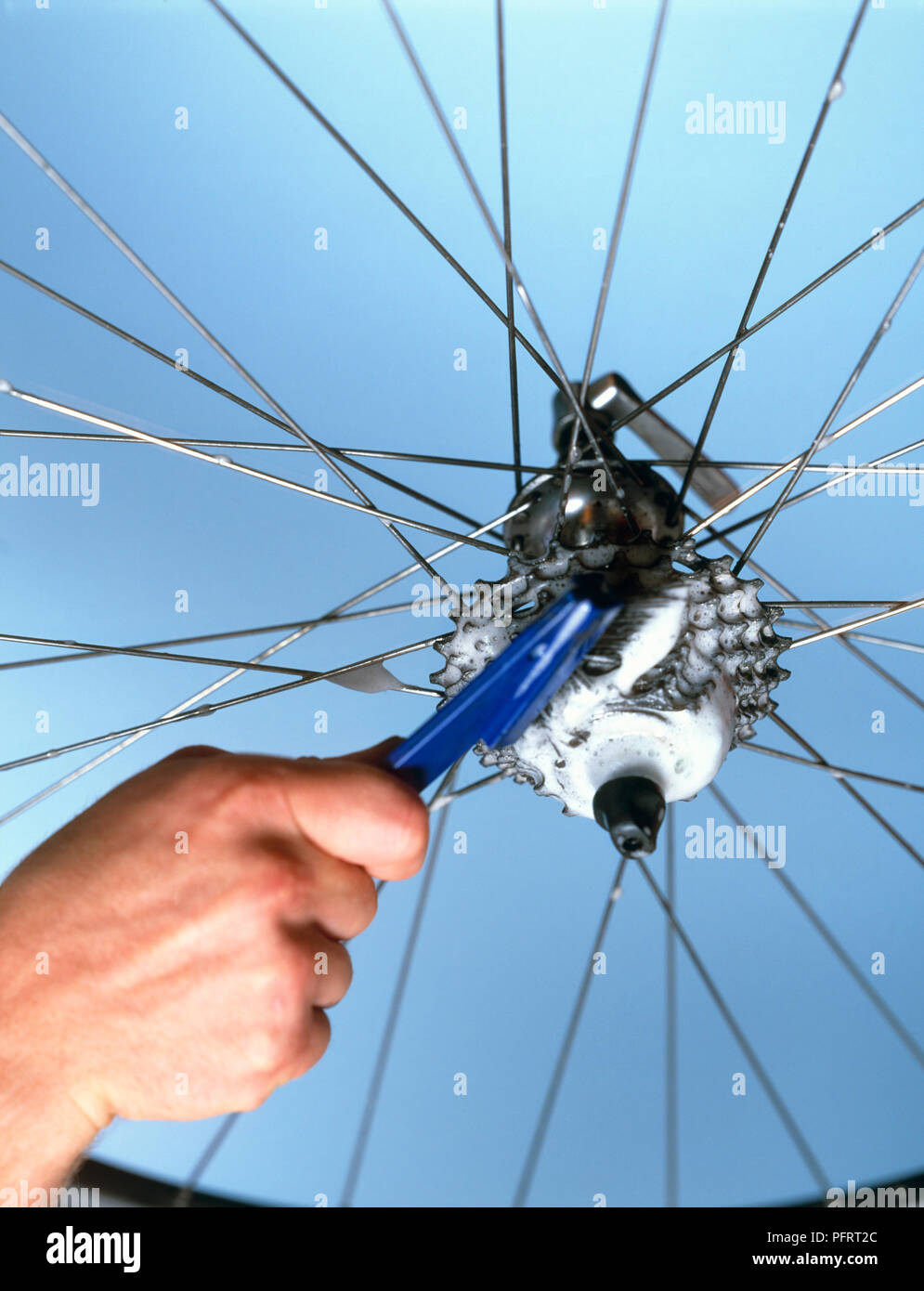 Man using soapy water and hard bristled brush to remove dirt from ...