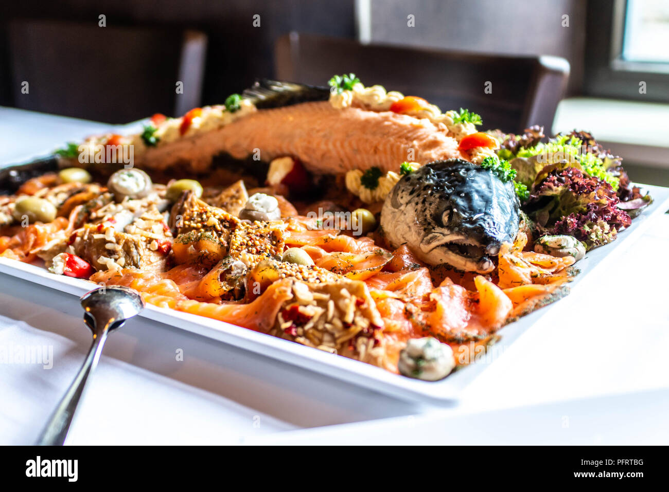 delicious big fish plate with complete fishbody and salmon steak with ...