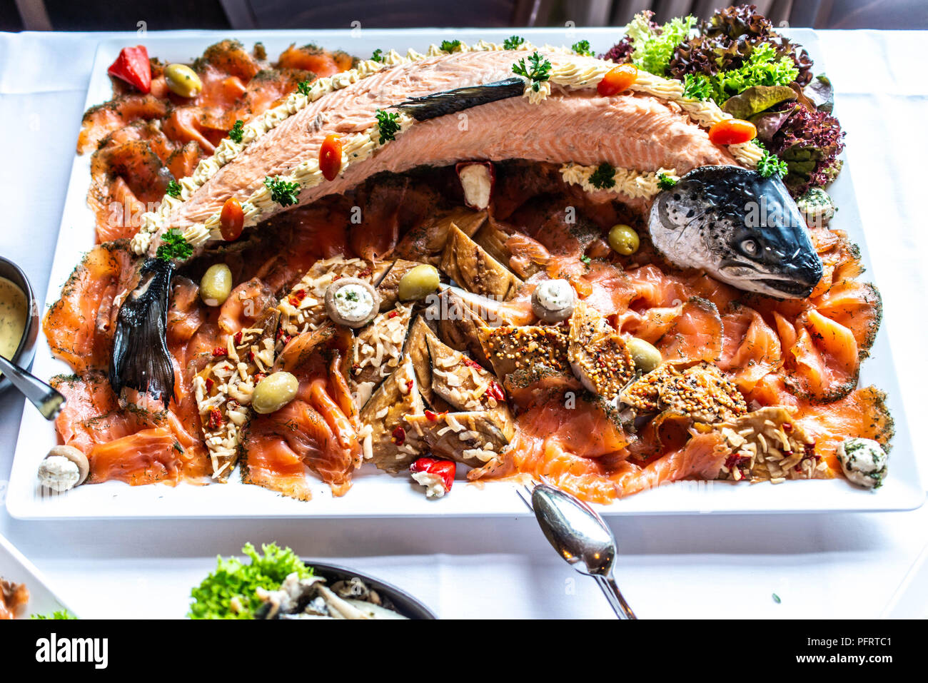 delicious big fish plate with complete fishbody and salmon steak with ...